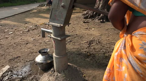 India, a woman operates a water pump in ... | Stock Video | Pond5