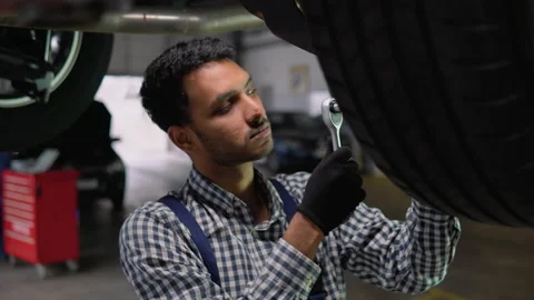 Indian car mechanic man working under li... | Stock Video | Pond5