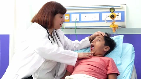 Indian female doctor check sick child pa... | Stock Video | Pond5