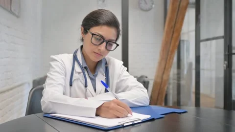 Indian Female Doctor Writing Medical Rep... | Stock Video | Pond5