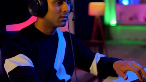 Indian gamer playing video games in a ho... | Stock Video | Pond5