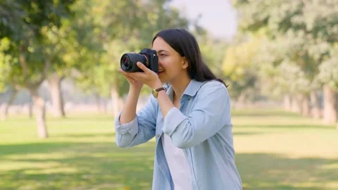 Indian girl clicking photos using camera | Stock Video | Pond5