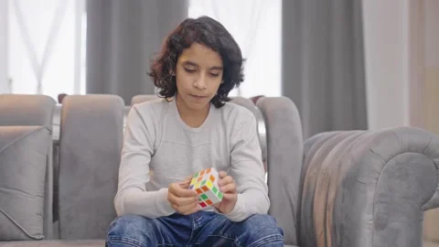 Indian kid boy solving Rubik's cube | Stock Video | Pond5