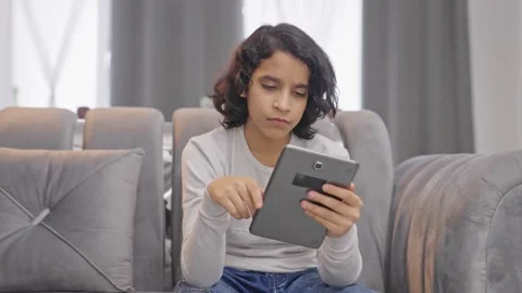 Indian kid using and scrolling through t... | Stock Video | Pond5