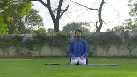 Indian man doing thunderbolt yoga pose | Stock Video | Pond5