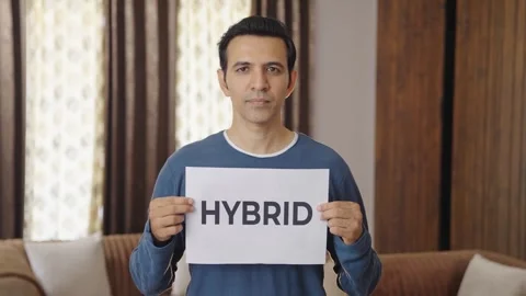 Indian man holding HYBRID banner | Stock Video | Pond5