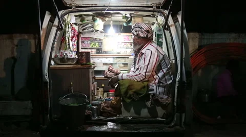 Indian man sitting at the back side of a... | Stock Video | Pond5