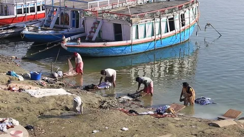 Indian men washed clothes in water river... | Stock Video | Pond5