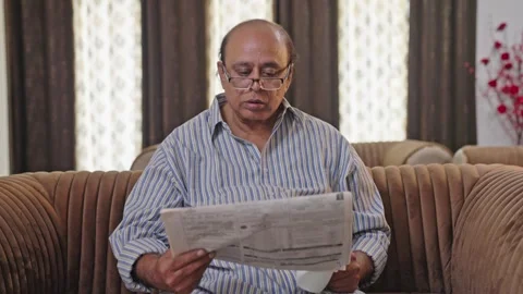 Indian old fat man reading newspaper | Stock Video | Pond5