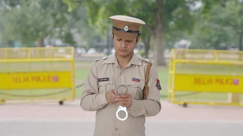 Indian police officer checking handcuffs | Stock Video | Pond5