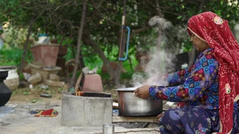 Indian poor woman in village cooking foo... | Stock Video | Pond5