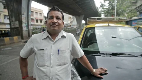 An Indian smiling taxi driver standing i... | Stock Video | Pond5