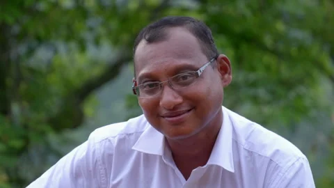 Indian specs portrait shot smiling in fr... | Stock Video | Pond5