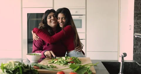 Indian woman hugging mum cooking togethe... | Stock Video | Pond5
