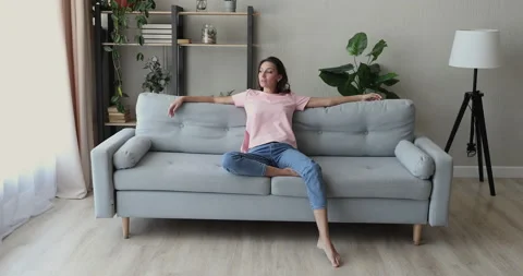 Indian woman lean on couch resting in li... | Stock Video | Pond5