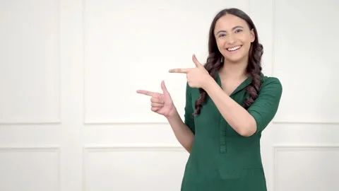 Indian woman pointing left at empty Copy... | Stock Video | Pond5