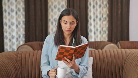 Indian woman reading a book | Stock Video | Pond5