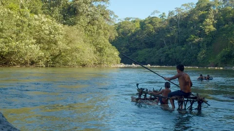 indigenous man sailing with his son on a... | Stock Video | Pond5
