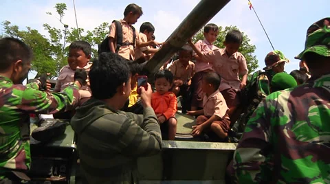Indonesian school kids play on tanks | Stock Video | Pond5