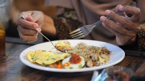 An Indonesian woman eating fried rice or... | Stock Video | Pond5
