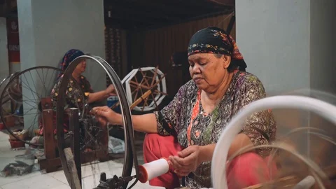 Indonesian woman using spinning wheel | Stock Video | Pond5