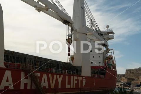 Photograph: Industrial boat offloading in Valletta, Malta harbor with ...