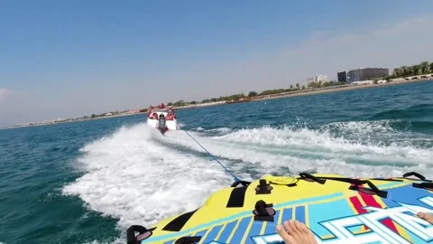 Inflatable couch raft pulled by sea moto... | Stock Video | Pond5