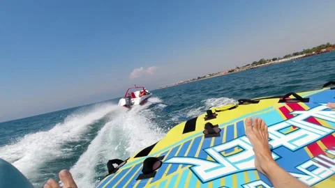 Inflatable couch raft pulled by sea moto... | Stock Video | Pond5