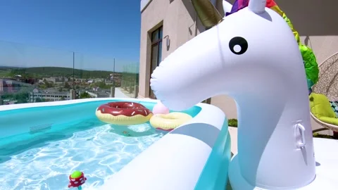 inflatable pool on rooftop patio at summ... | Stock Video | Pond5