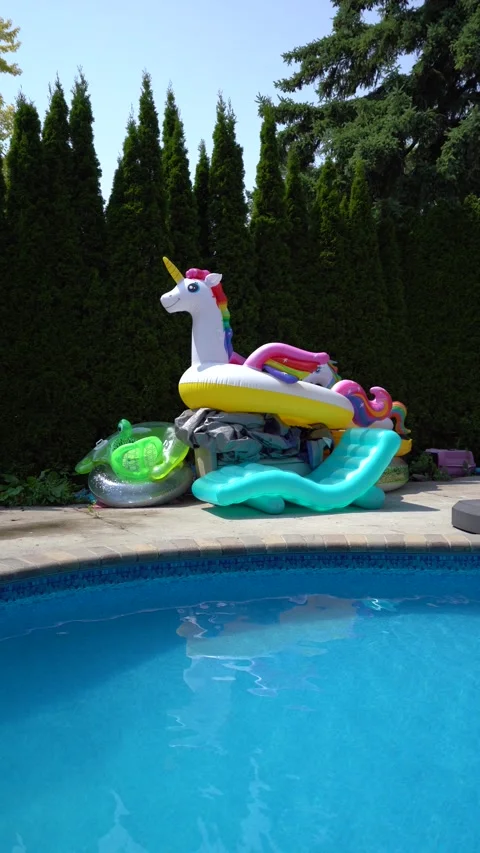Inflatable raft unicorn by the pool | Stock Video | Pond5