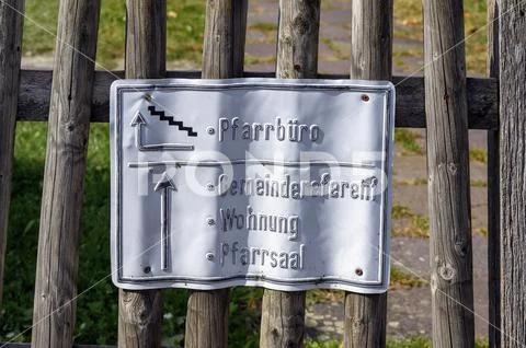 Info sign parish office parish hall on a wooden fence Bad Groenenbach ...