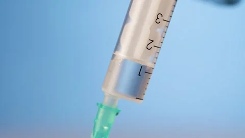Injecting liquid medication through medi... | Stock Video | Pond5