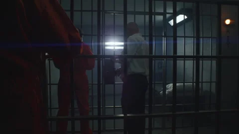 Inmate goes inside prison cell, sits dow... | Stock Video | Pond5
