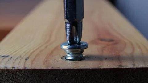 Insert a screw into the wood using Cordl... | Stock Video | Pond5