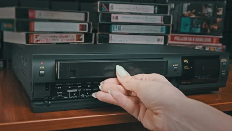 Insert VHS Cassette into VCR and Push Pl... | Stock Video | Pond5