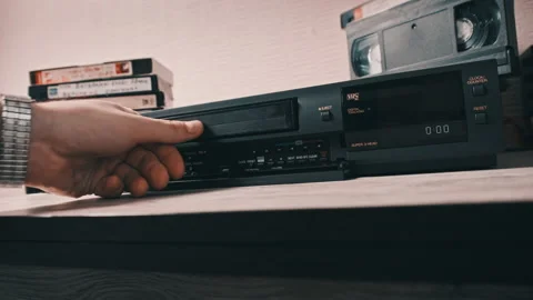 Insert VHS Cassette Into VCR Player | Stock Video | Pond5