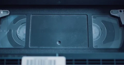 Inserting VHS video tape into retro VCR ... | Stock Video | Pond5