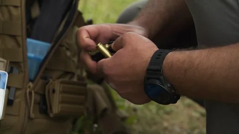 inserts sniper rifle cartridges into the... | Stock Video | Pond5