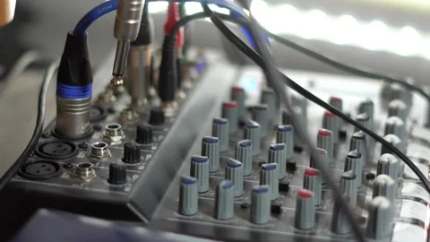 inserts wires into the mixing console | Stock Video | Pond5