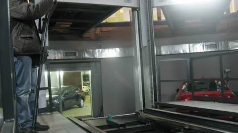 Inside storage tower platform moving car... | Stock Video | Pond5
