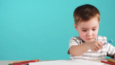 Inspired little boy at the table draw wi... | Stock Video | Pond5