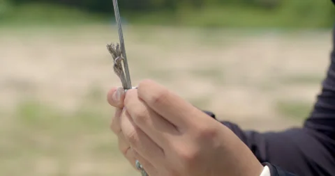 Install the wire rope clip.Turn the nut ... | Stock Video | Pond5