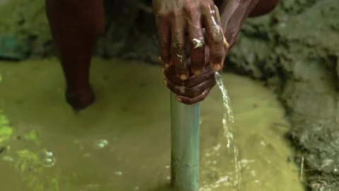 installing a water pump in a remote vill... | Stock Video | Pond5
