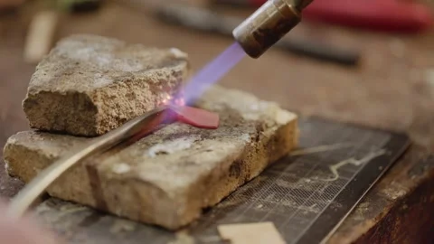 Instrument maker heating metal bar to fo... | Stock Video | Pond5