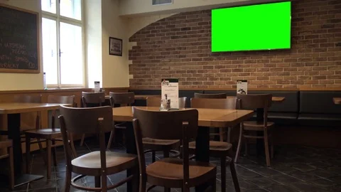The interior of a bar with a green scree... | Stock Video | Pond5