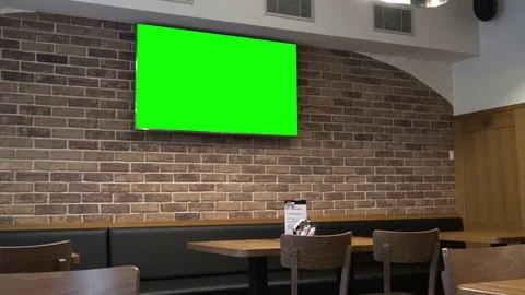 The interior of a bar with a green scree... | Stock Video | Pond5