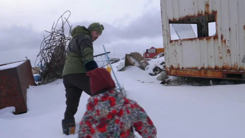 Inuit father, child walk thru Greenland ... | Stock Video | Pond5