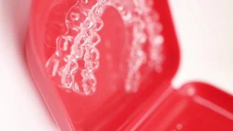 Invisalign clear aligner in red containe... | Stock Video | Pond5