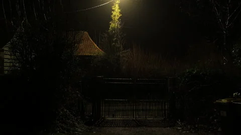 Iron gate in drizzly night in front of ... | Stock Video | Pond5