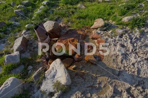 Iron pipe flowing clean drinking water . spring water from the ground ...